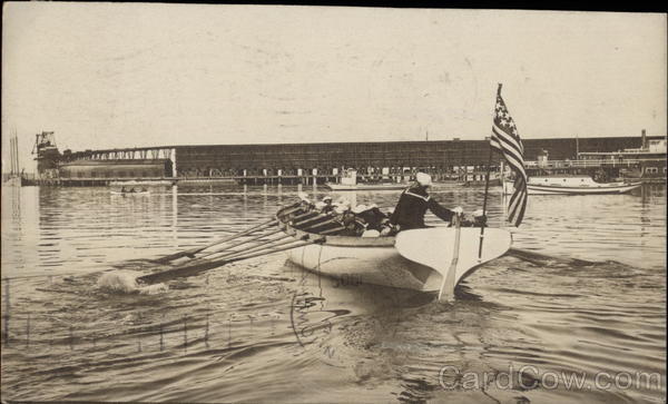 Sailors rowing cutter in harbor Navy