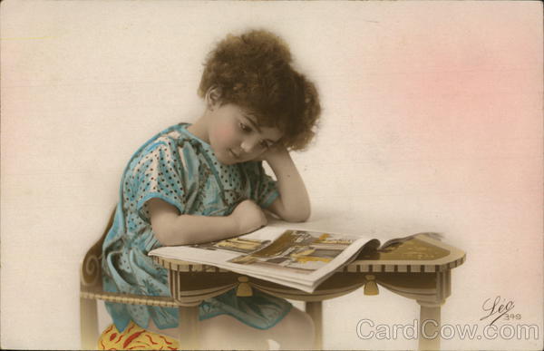 A Young Child Sitting at a Desk Reading a Magazine Children Leo Postcard