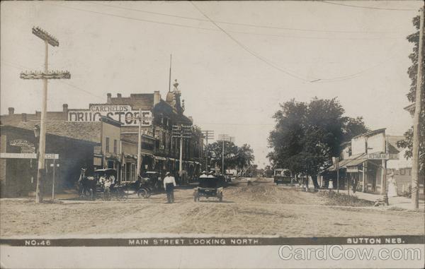 Main Street Looking North - Carl Held's Drug Store Sutton, NE Postcard