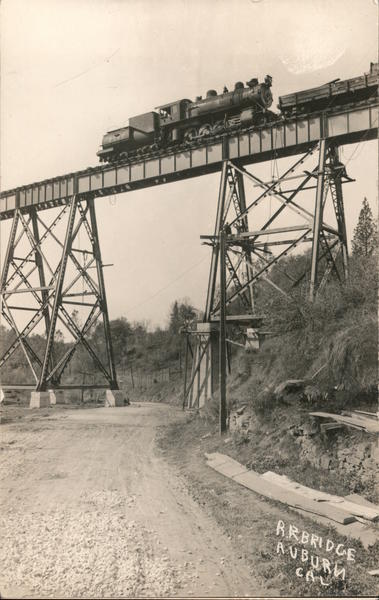 Railroad bridge with a steam locomotive crossing it Auburn, CA Postcard