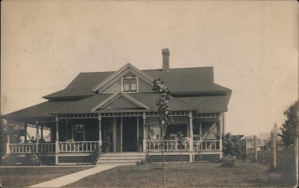 Photograph of the front of a house Oden, MI Postcard